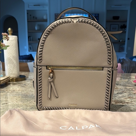 Calpak | Bags | Calpak Kaya Faux Leather Round Backpack In Sand | Poshmark